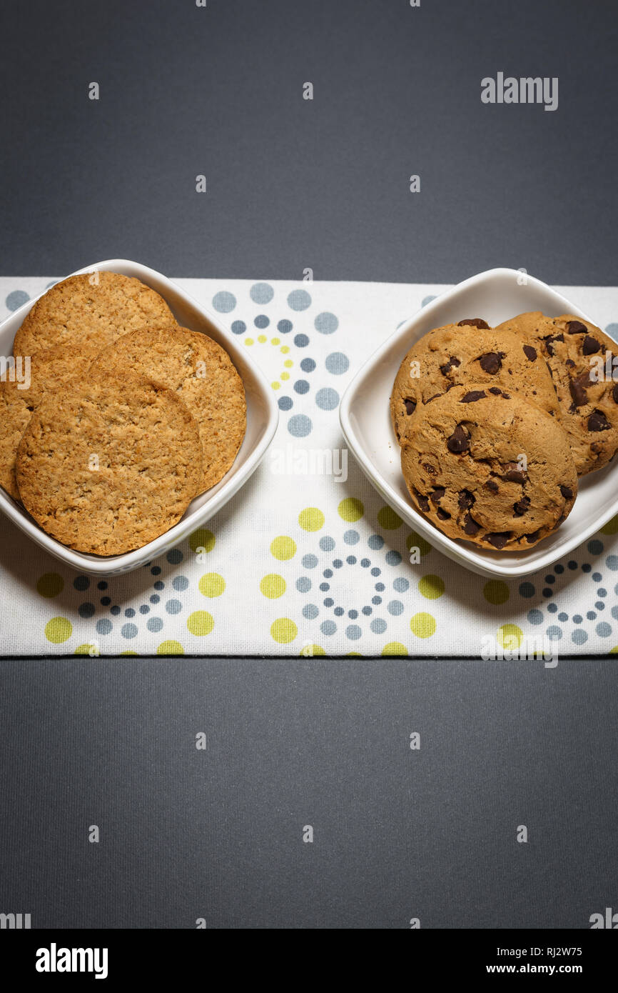 Two different kind of cookies, oatmeal and chocolate chip cookies in ...