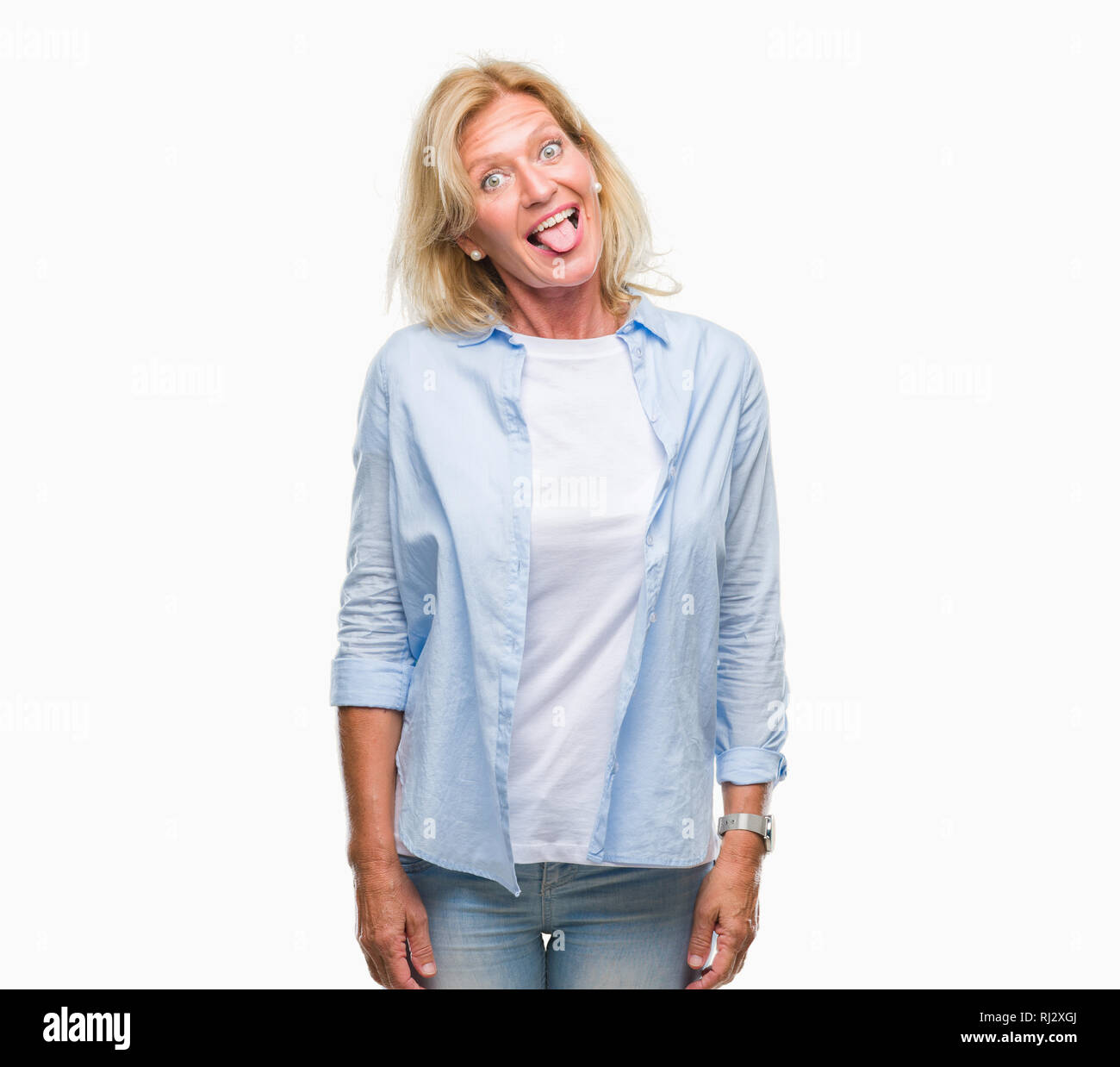 Middle age blonde woman over isolated background sticking tongue out happy with funny expression ...