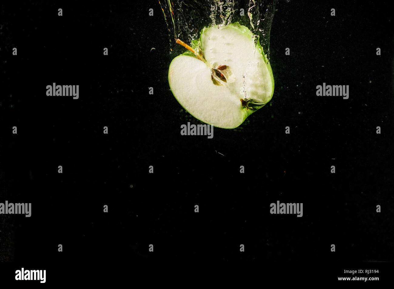 Half apple falls in water hi-res stock photography and images - Alamy