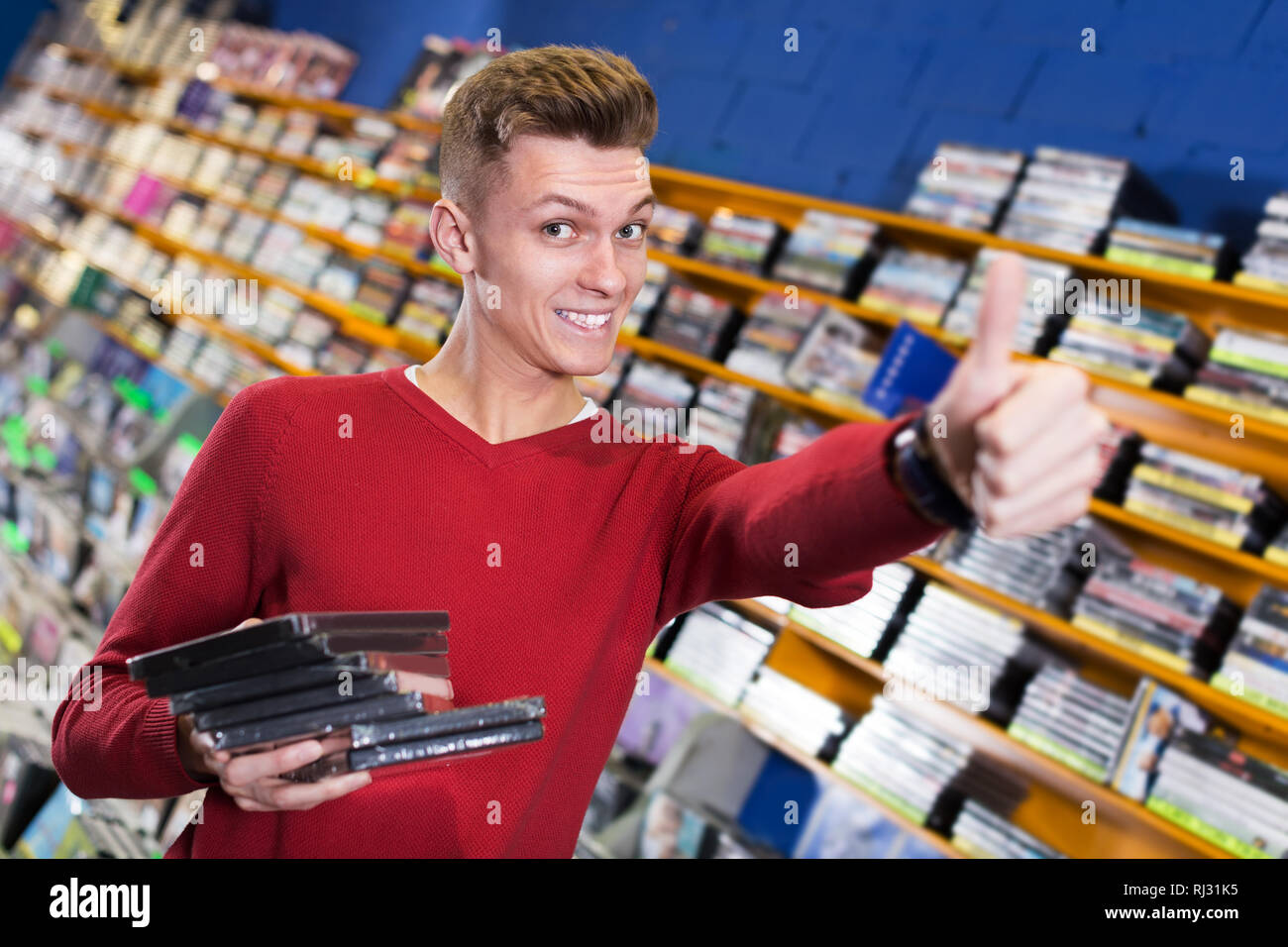 Man holding stack of dvds hi-res stock photography and images - Alamy