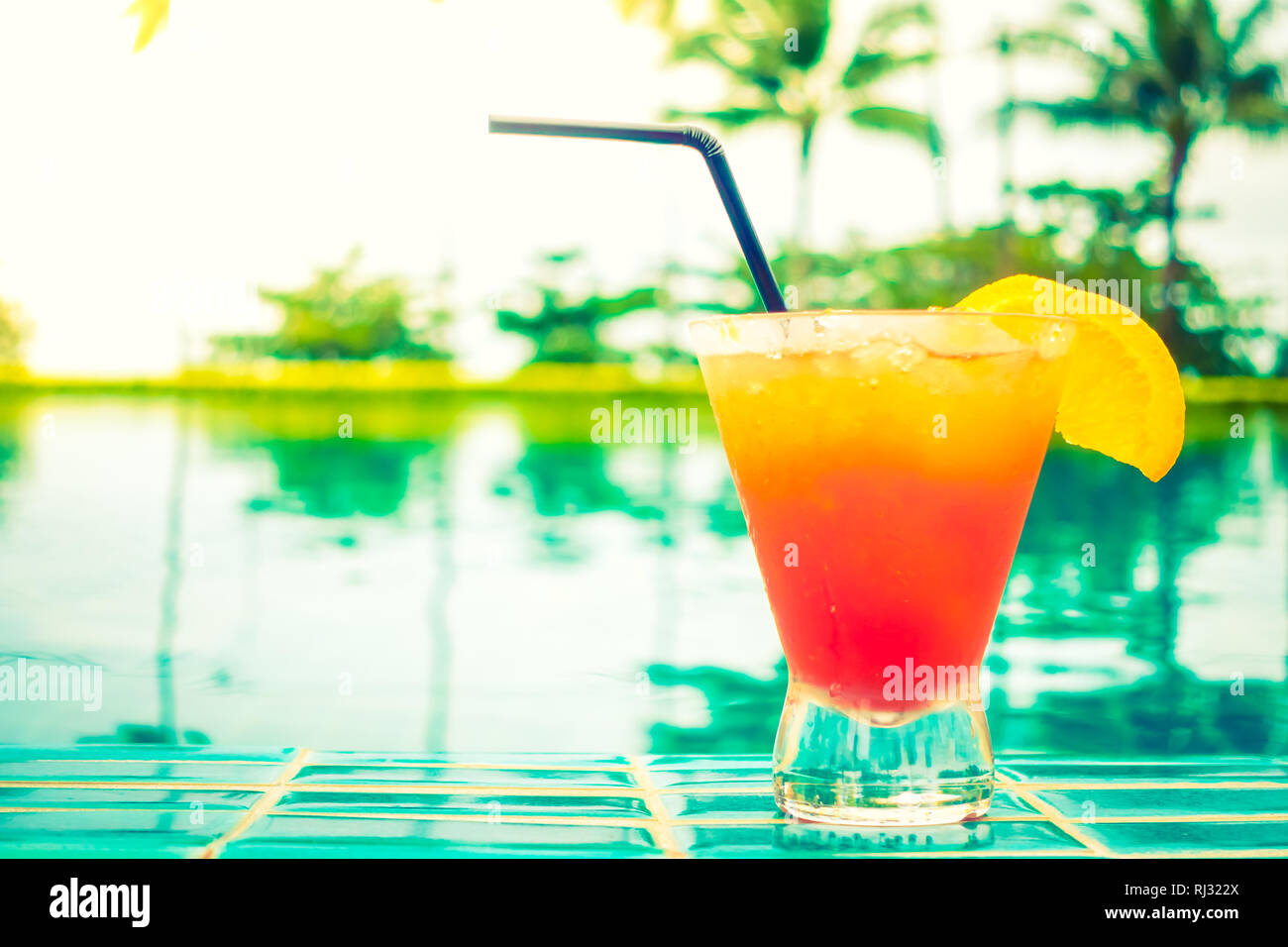 Mocktails glass around swimming pool in hotel resort - Vintage Filter ...