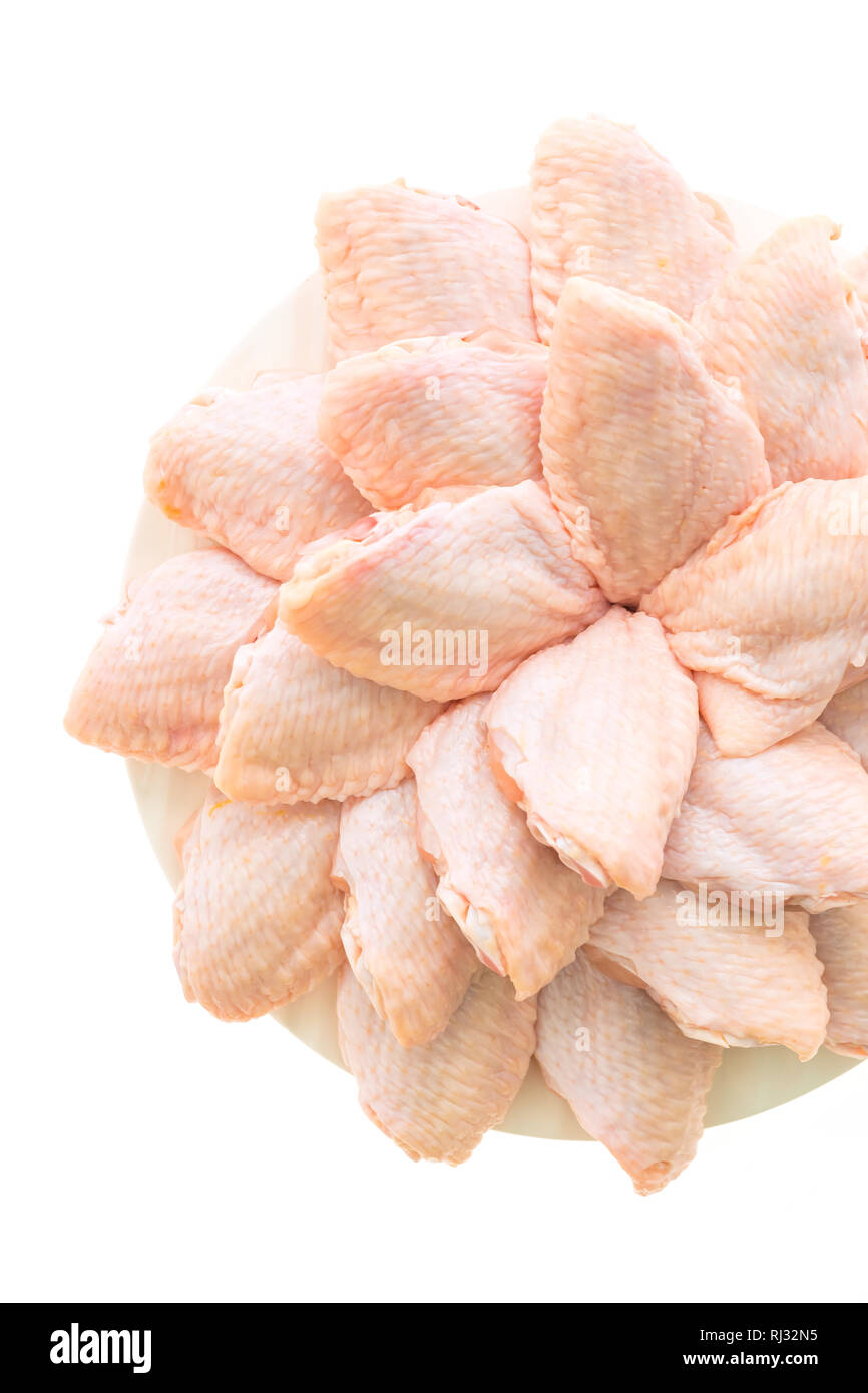 Raw fresh chicken meat and wing in white plate isolated on white ...