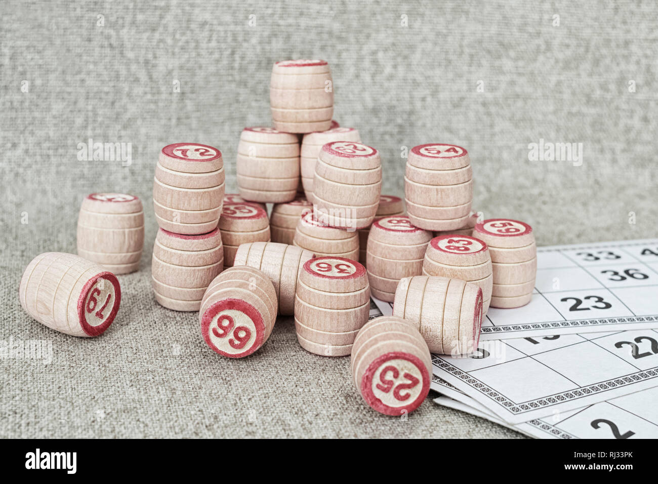 Lotto game with wooden barrels and cards with numbers on canvas ...