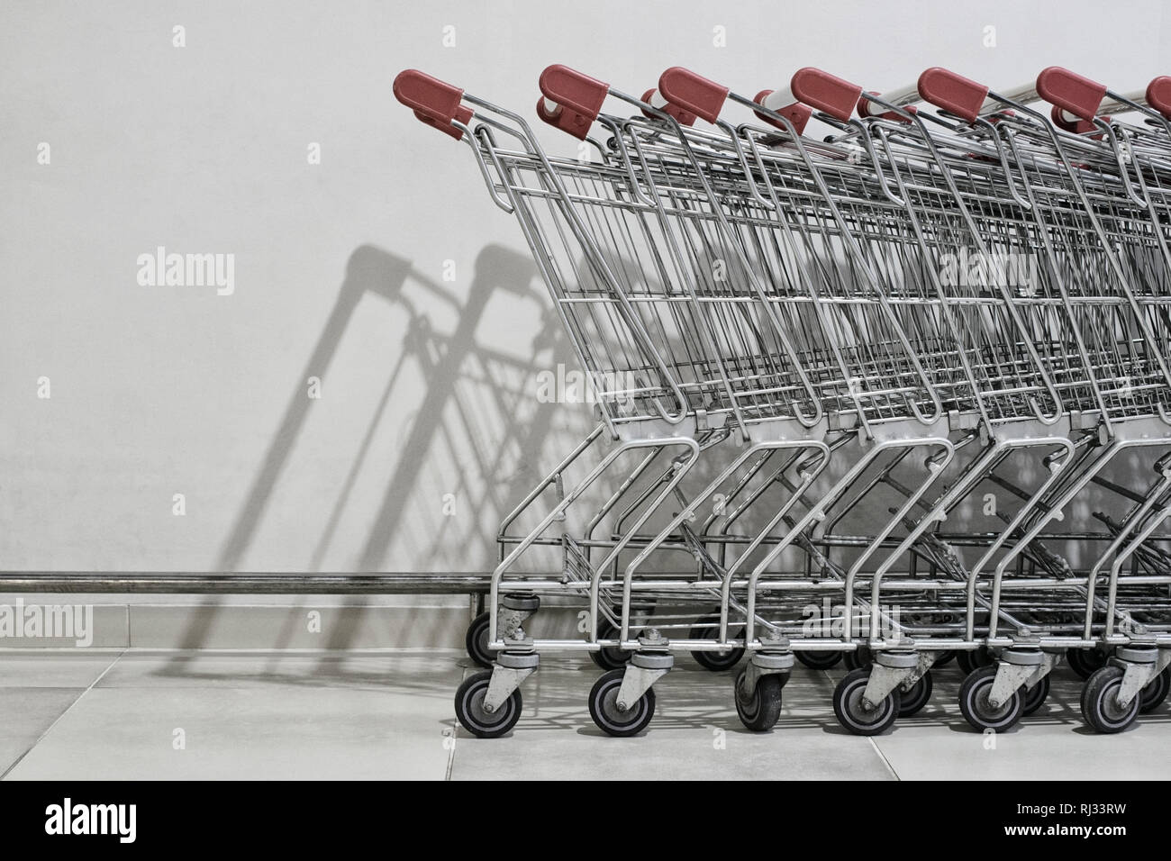 Shop iron carts on wheels stand against the wall in a row in the store ...