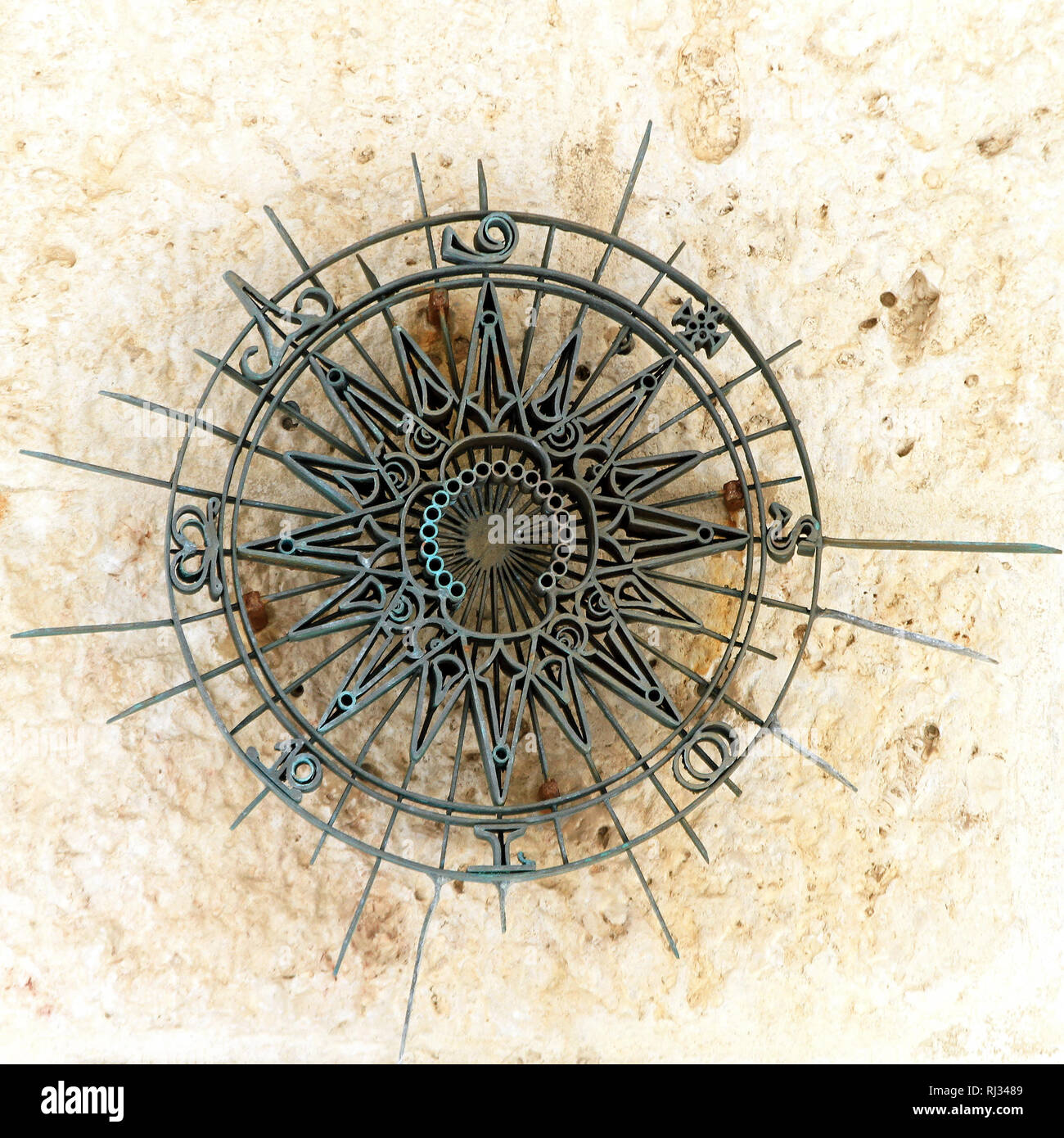 Cardinal points decor made from old iron Stock Photo - Alamy