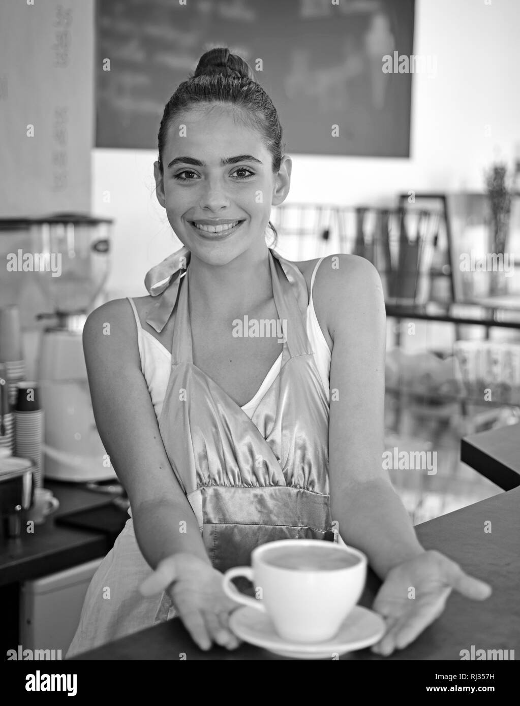 Your cup of inspiration. Happy woman barista in coffee shop. Pretty ...