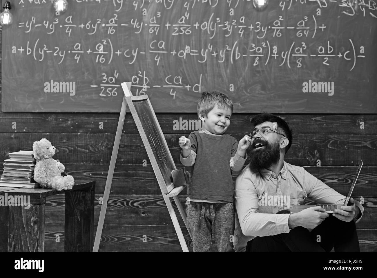 Daddy and kid having fun while learning new skills. Smiling teacher and ...