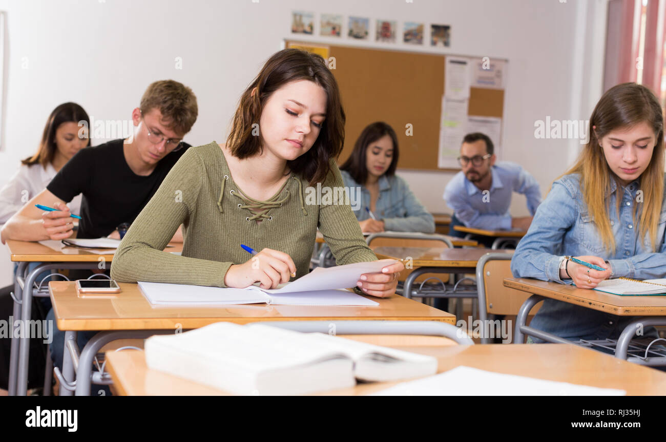 Girl is writing test and answer about task in the classroom Stock Photo ...