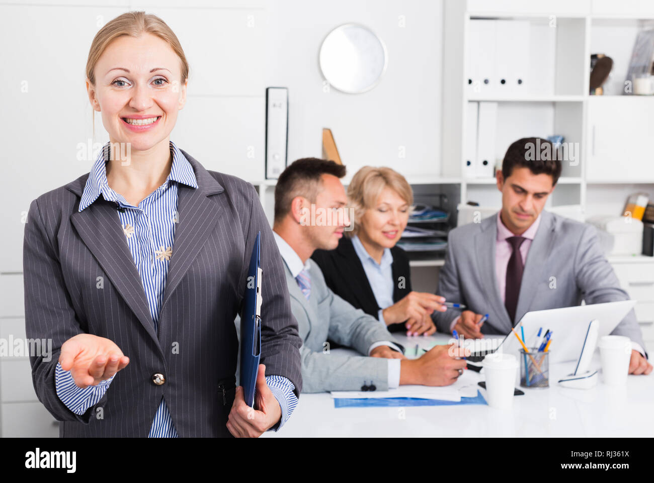 Business woman politely welcoming hi-res stock photography and images ...