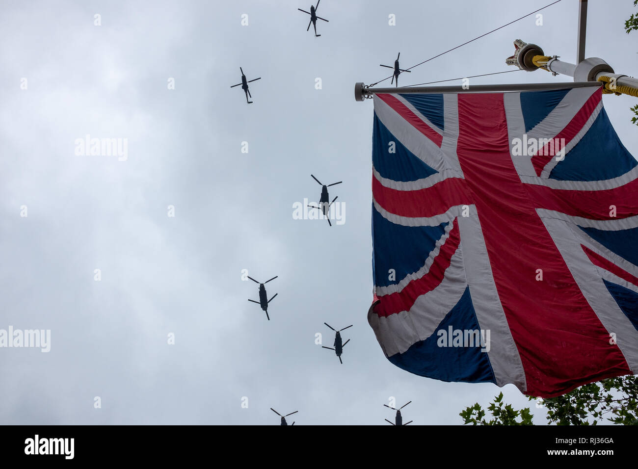 Royal Air Force helicopters fly past a Union flag (British flag ...