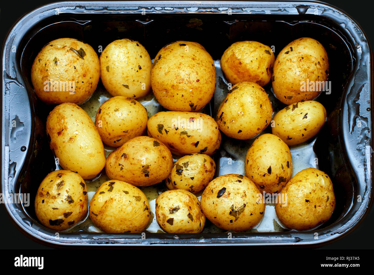 Prepared small potatoes in plastic microwave pot Stock Photo - Alamy