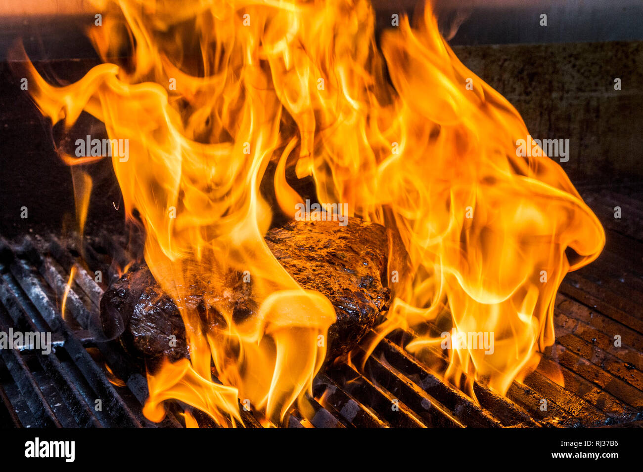 A large Rump beef steak being flame grilled Stock Photo - Alamy