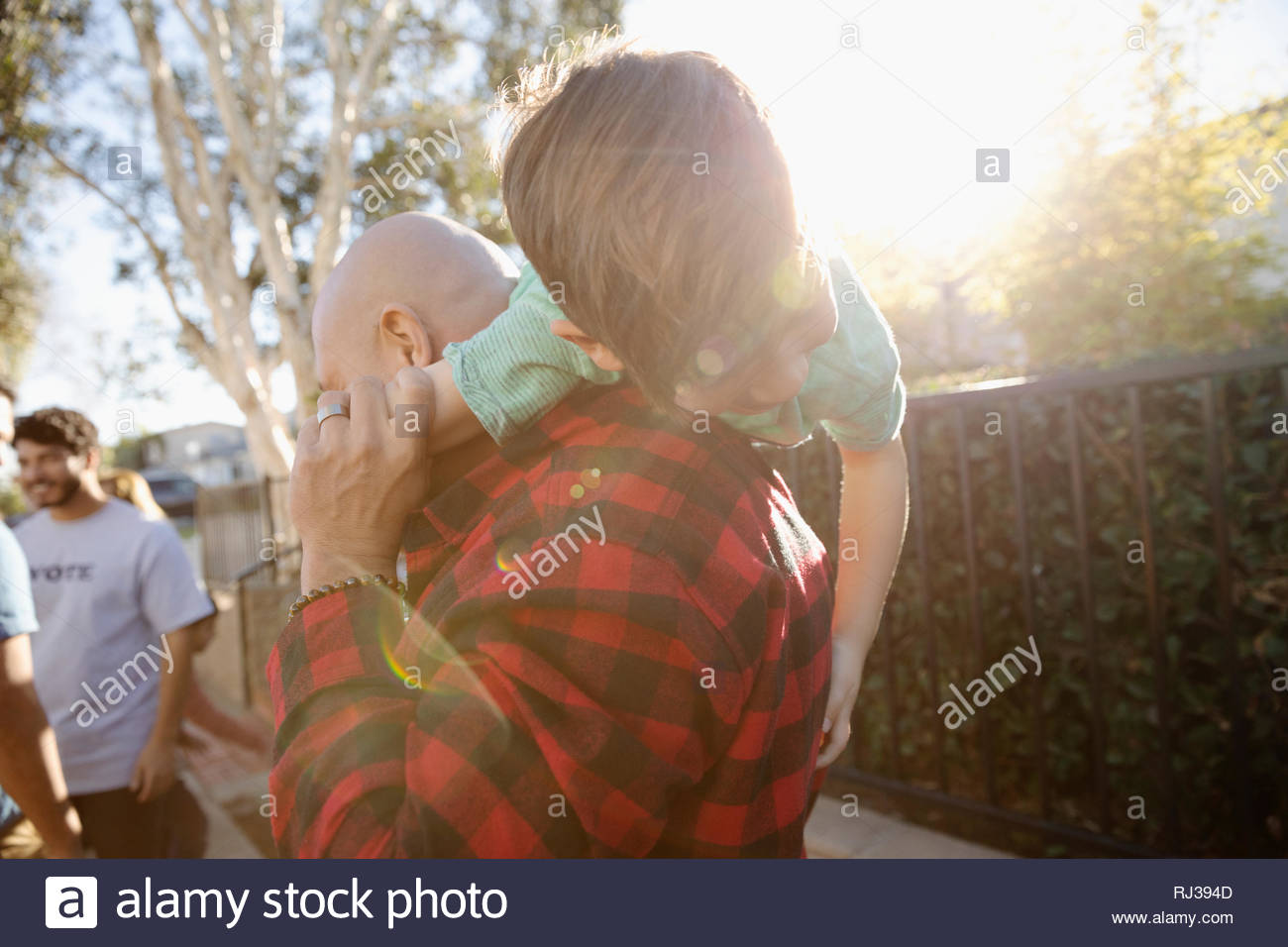 Father carrying son over shoulder hi-res stock photography and images ...