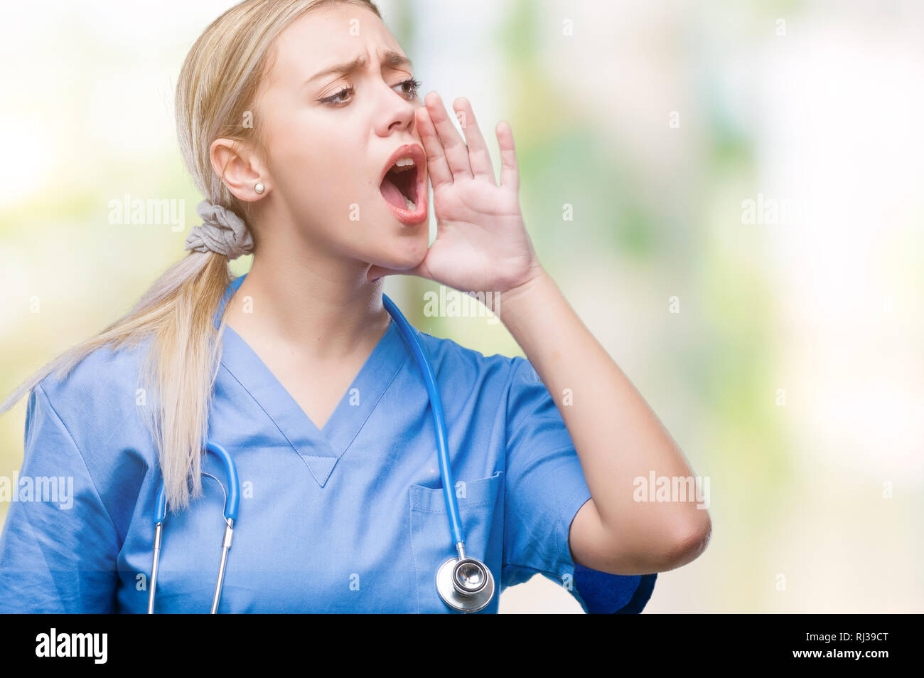 Young blonde surgeon doctor woman over isolated background shouting and ...