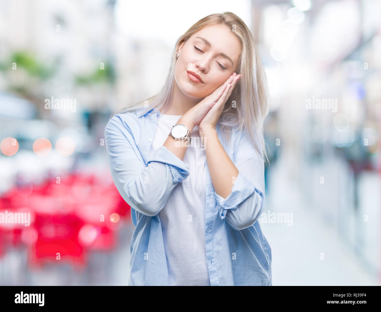 Young blonde woman over isolated background sleeping tired dreaming and ...