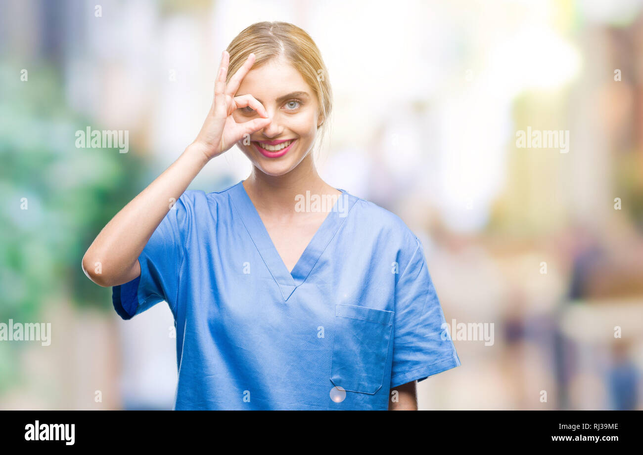 Young beautiful blonde doctor surgeon nurse woman over isolated ...