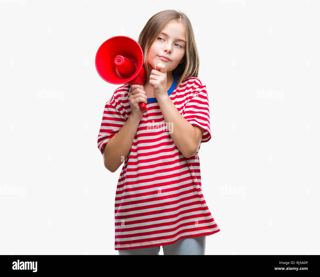 Young beautiful girl yelling through megaphone over isolated background ...