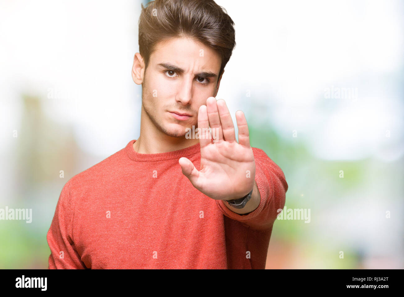 Young handsome man over isolated background doing stop sing with palm ...
