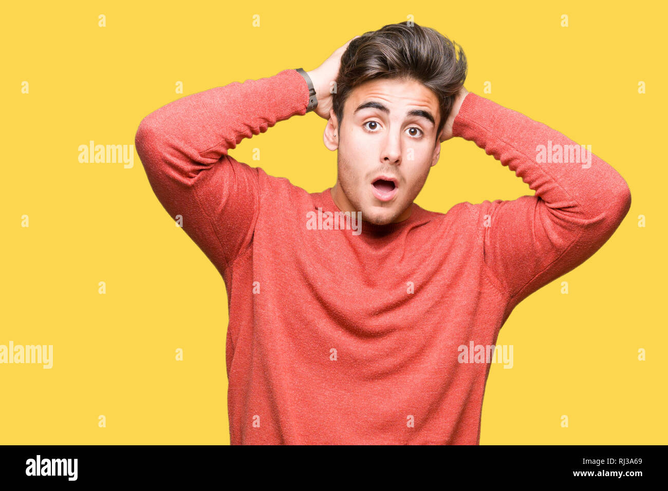 Young handsome man over isolated background Crazy and scared with hands ...