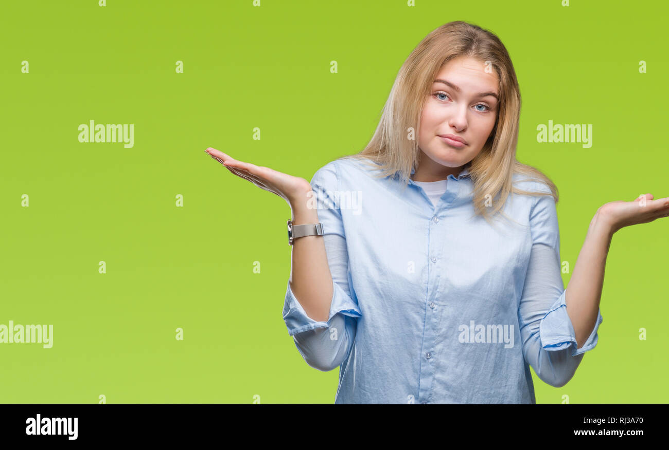 Young caucasian business woman over isolated background clueless and ...