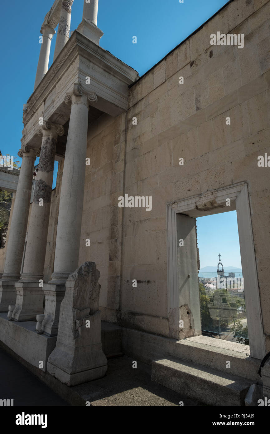 Flanked by striking marble columns on one side, an opening in back wall ...