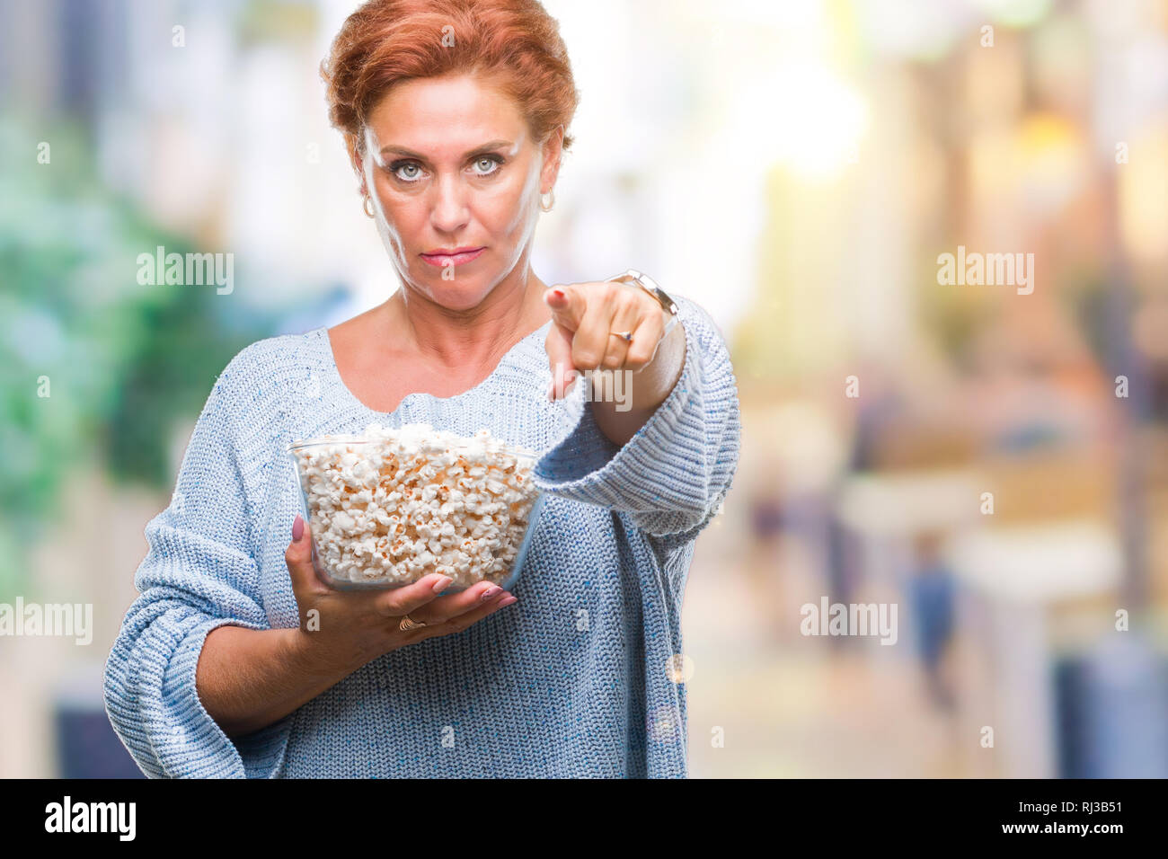Senior woman eating popcorn camera hi-res stock photography and images ...