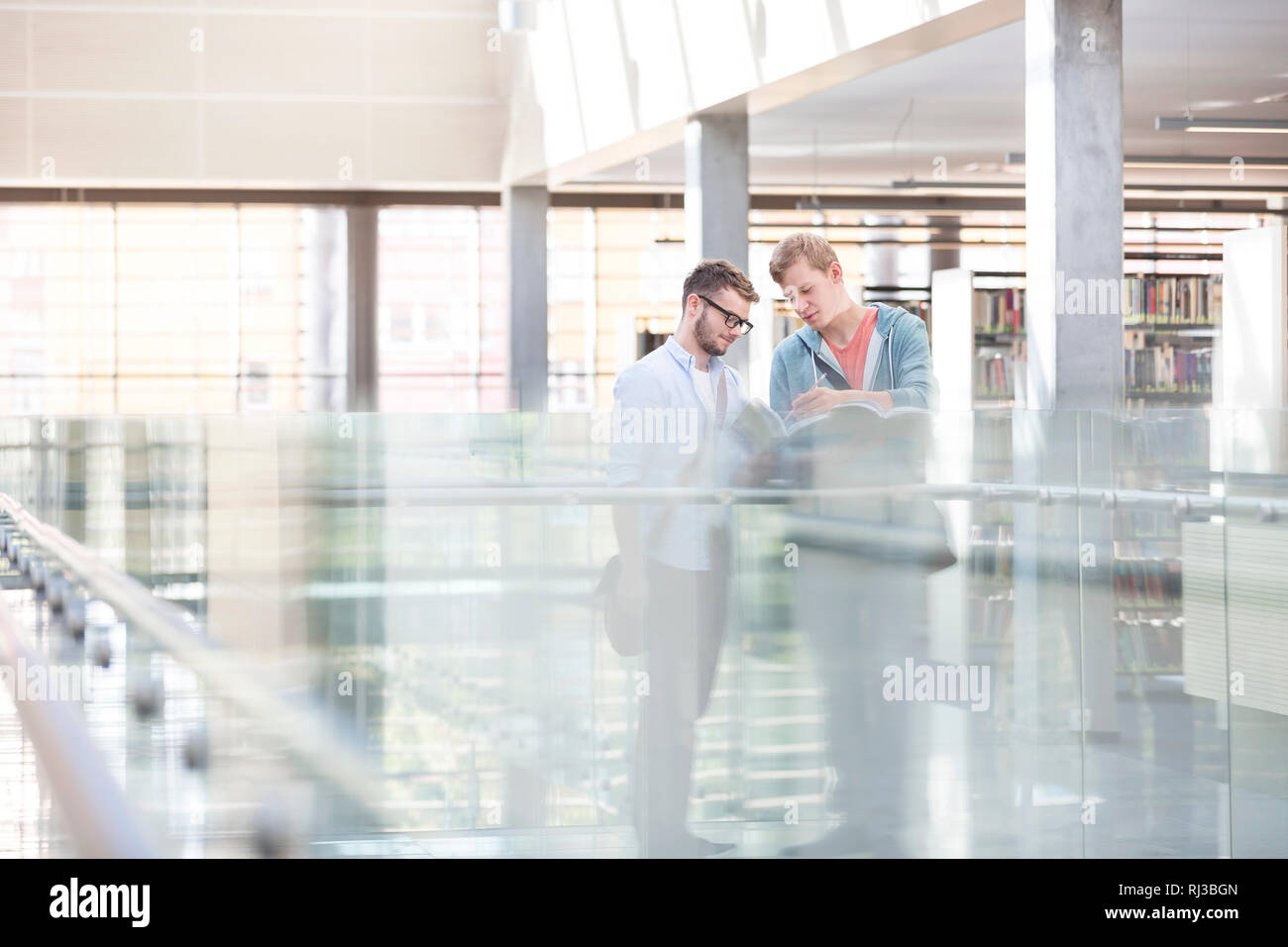 Happy students standing in library hi-res stock photography and images ...