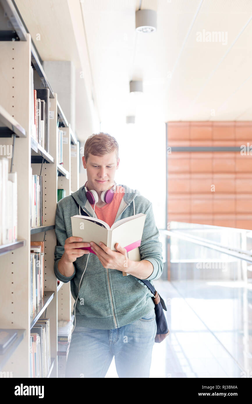 Male student reading book hi-res stock photography and images - Alamy