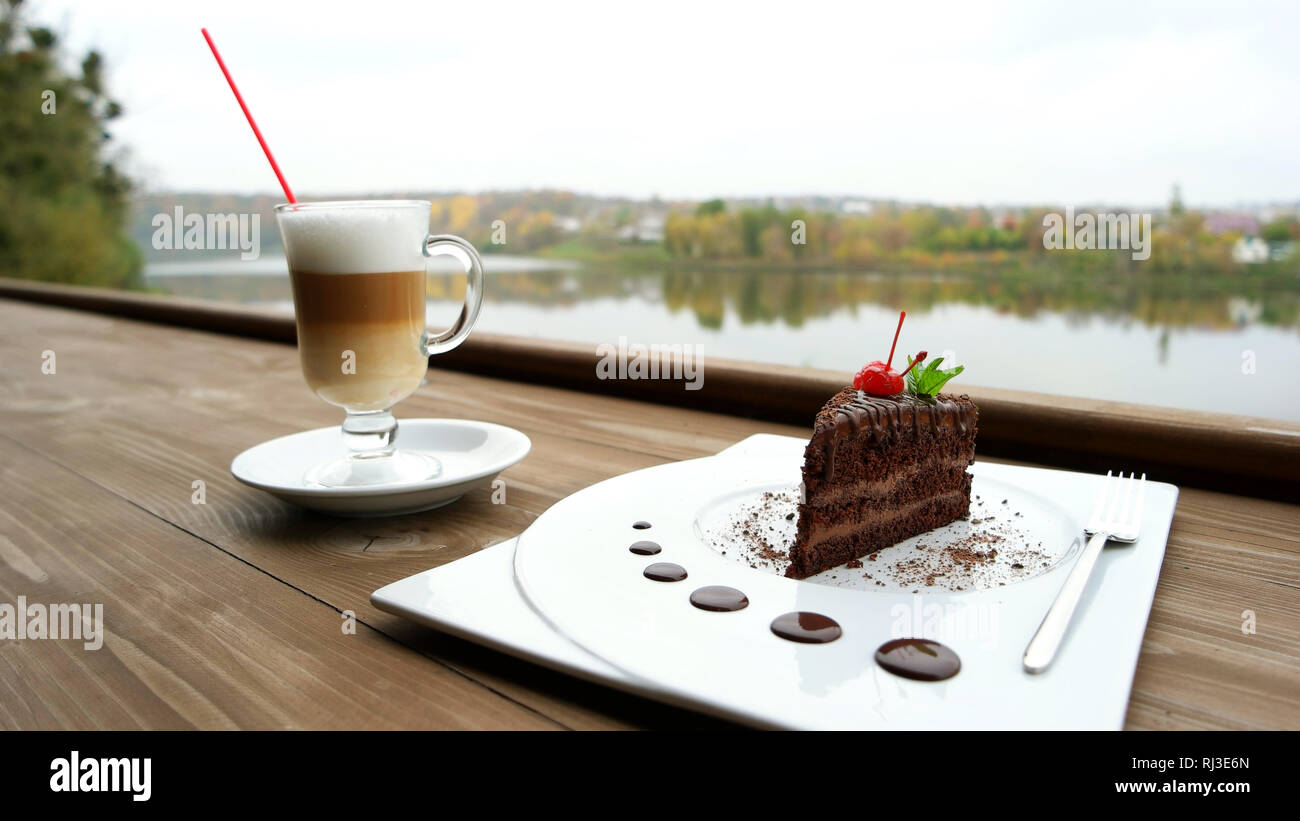 Chocolate cake and coffee drink outdoors Stock Photo - Alamy