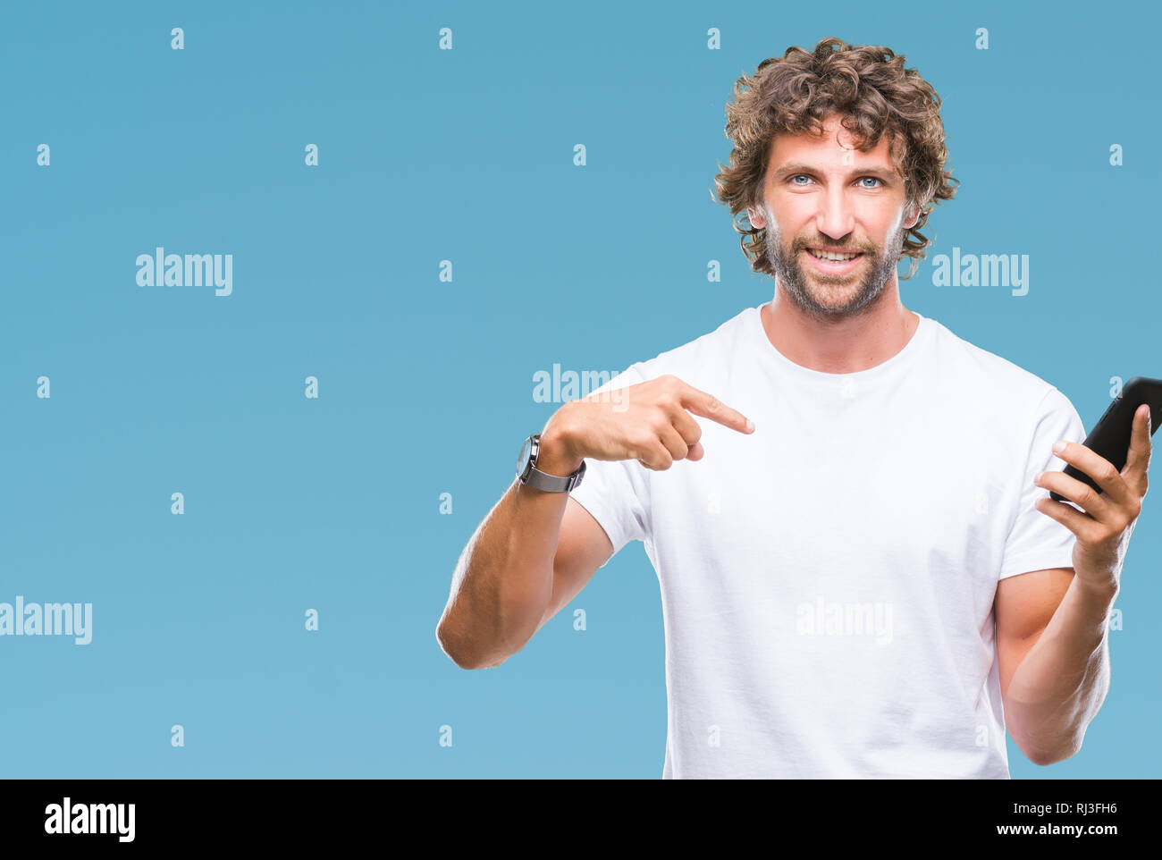 Handsome hispanic man model sending message texting using smartphone ...