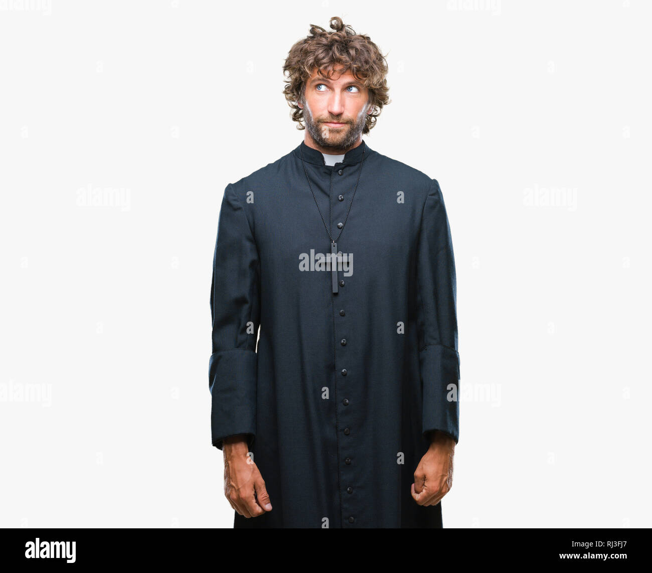 Handsome hispanic catholic priest man over isolated background smiling ...