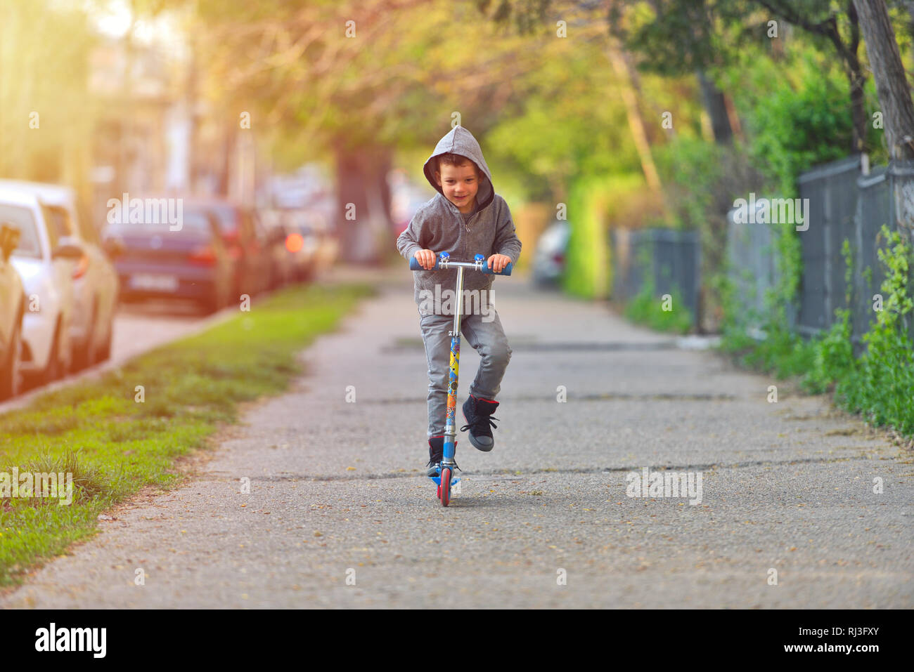 Child kid scooter riding fun happy hi-res stock photography and images ...