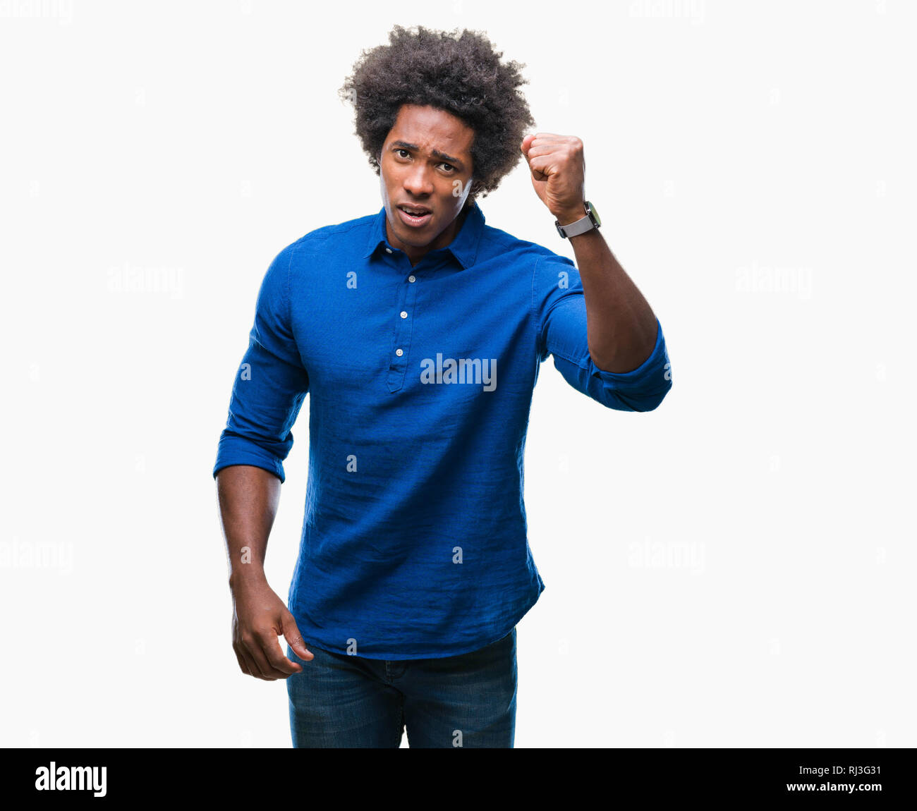 Afro american man over isolated background angry and mad raising fist ...