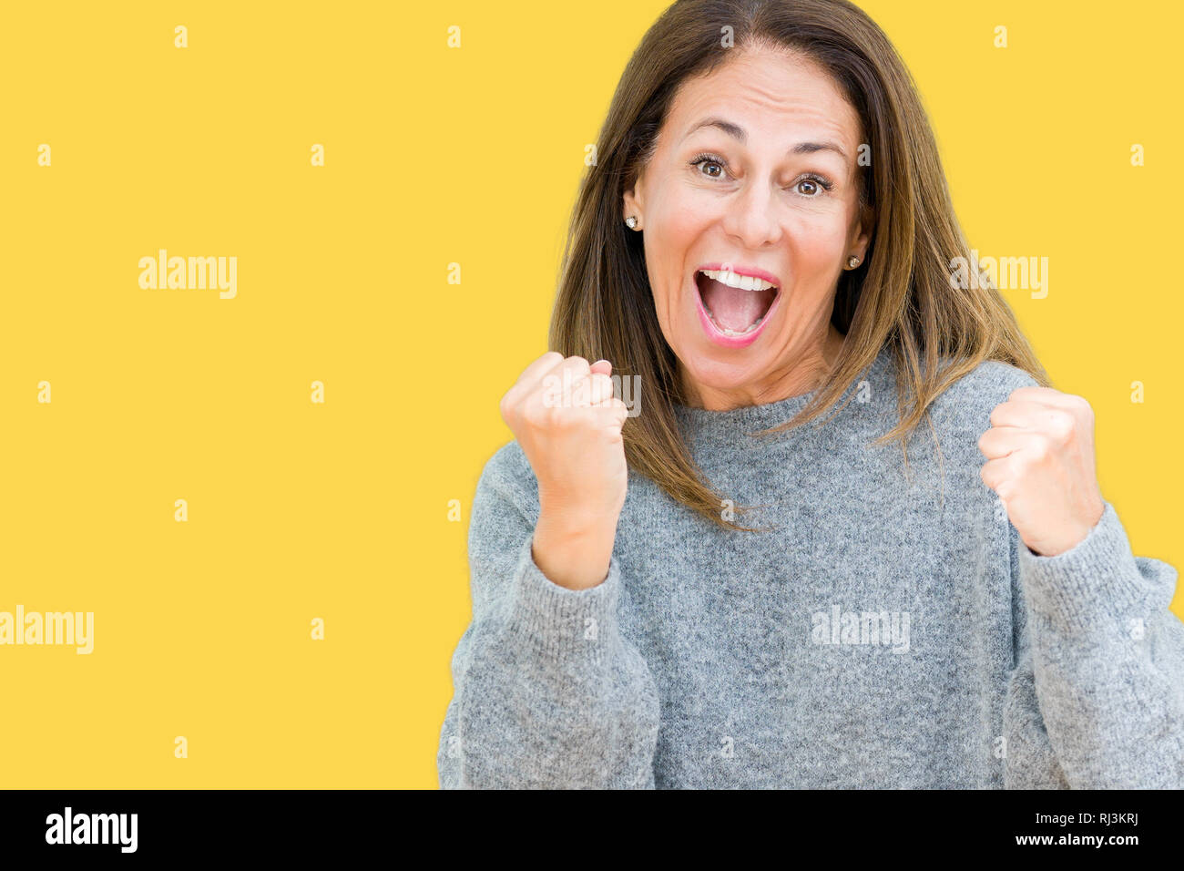 Beautiful middle age woman wearing winter sweater over isolated ...