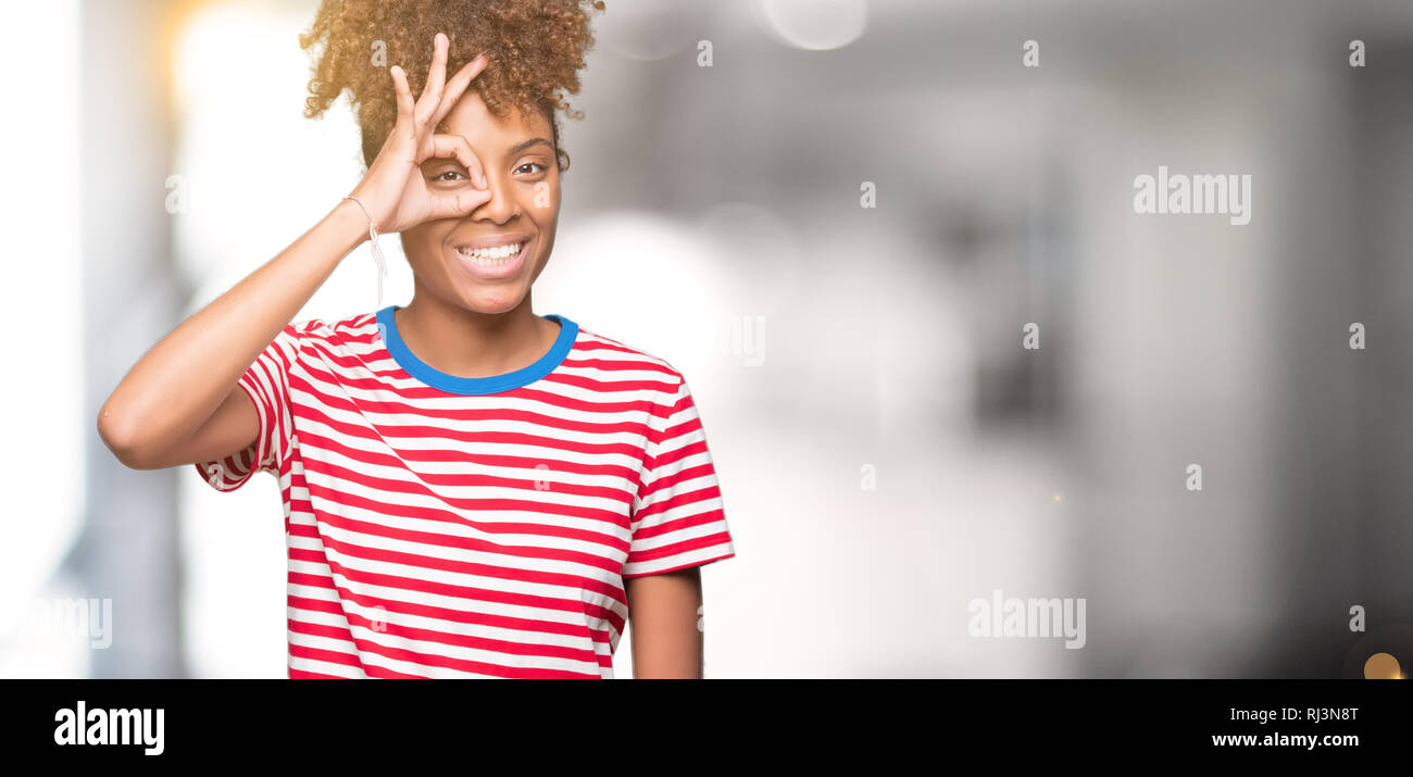 Beautiful young african american woman over isolated background doing ...
