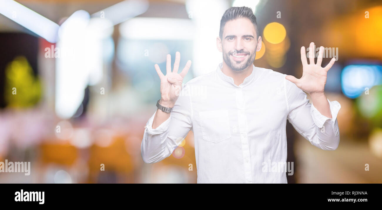 Young business man over isolated background showing and pointing up ...