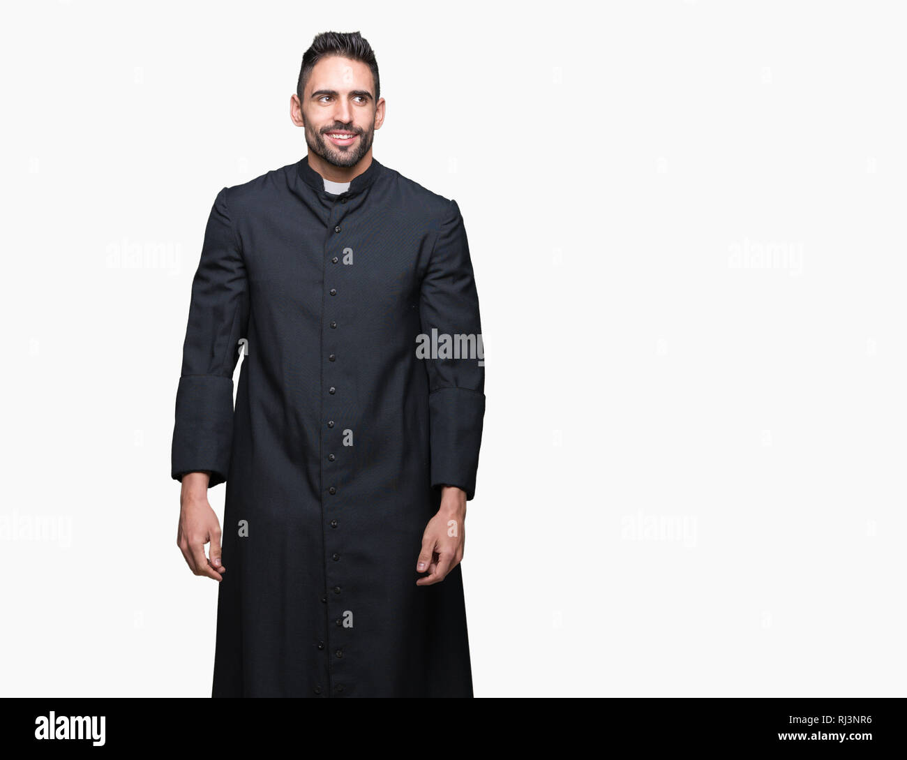 Young Christian priest over isolated background smiling looking side ...