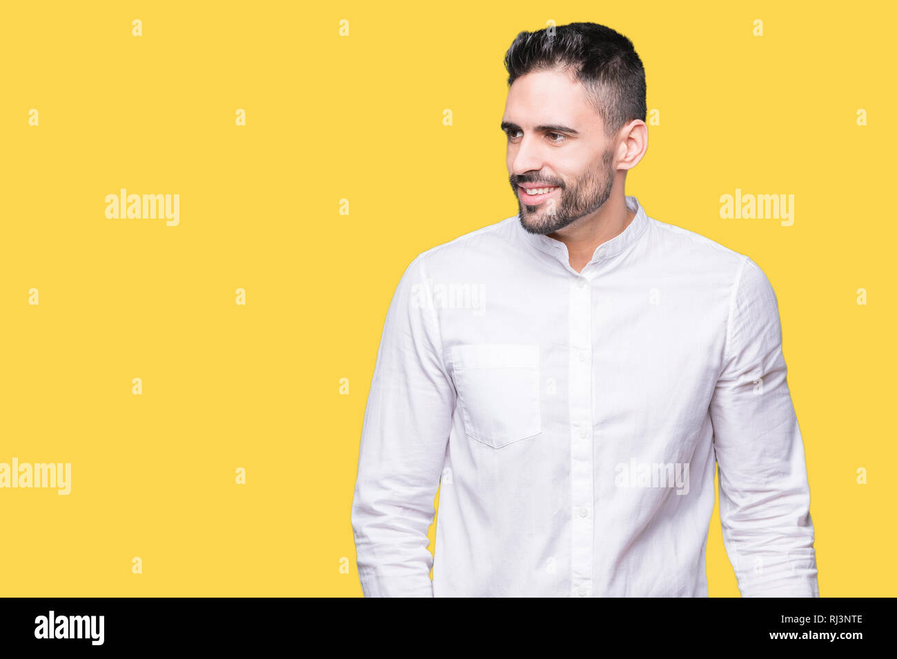 Young business man over isolated background looking away to side with ...