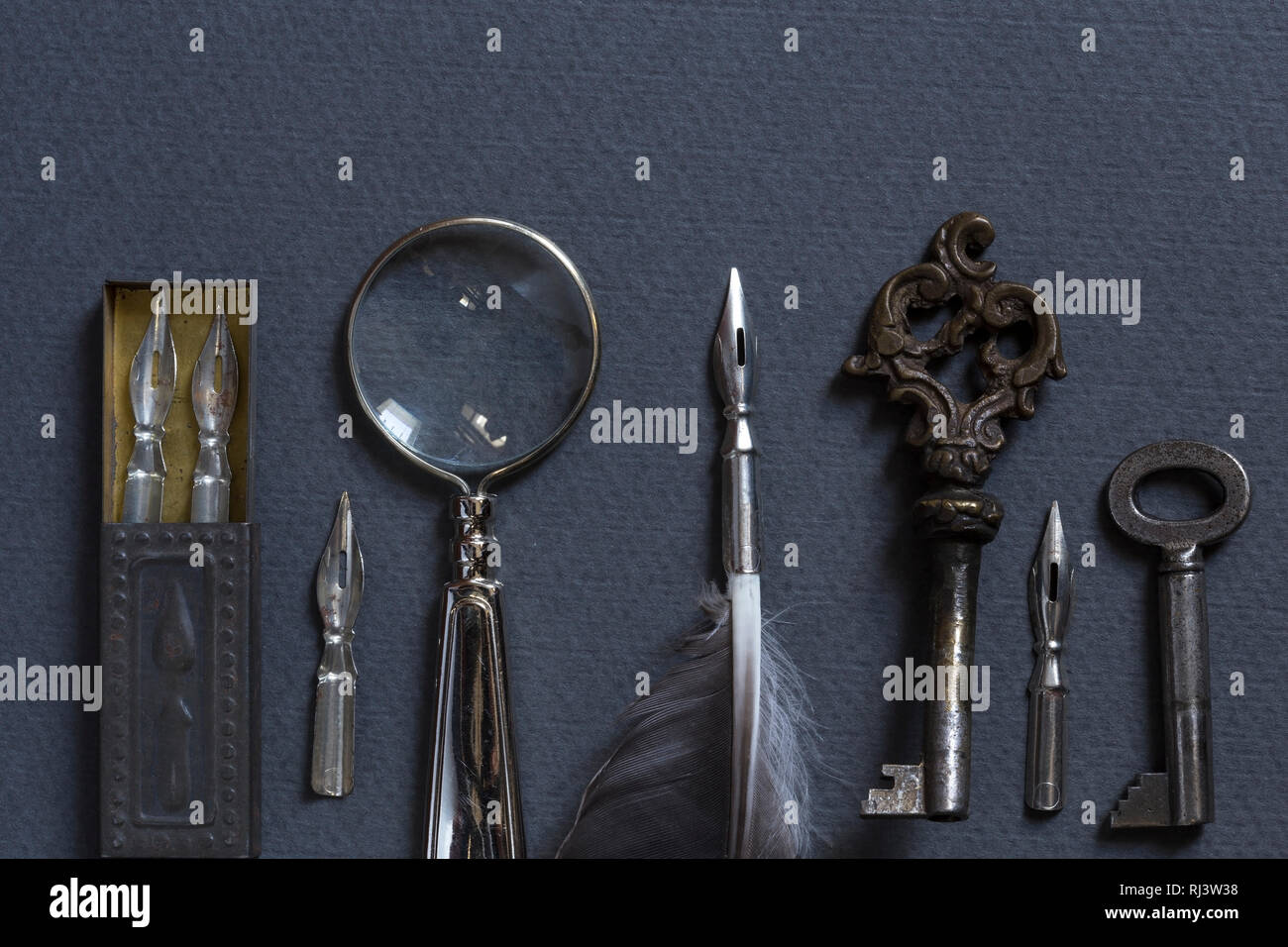 Vintage writing set on a gray cardboard background Stock Photo - Alamy