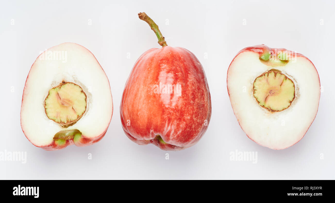 Half cut rose apple with seed on white background Stock Photo - Alamy