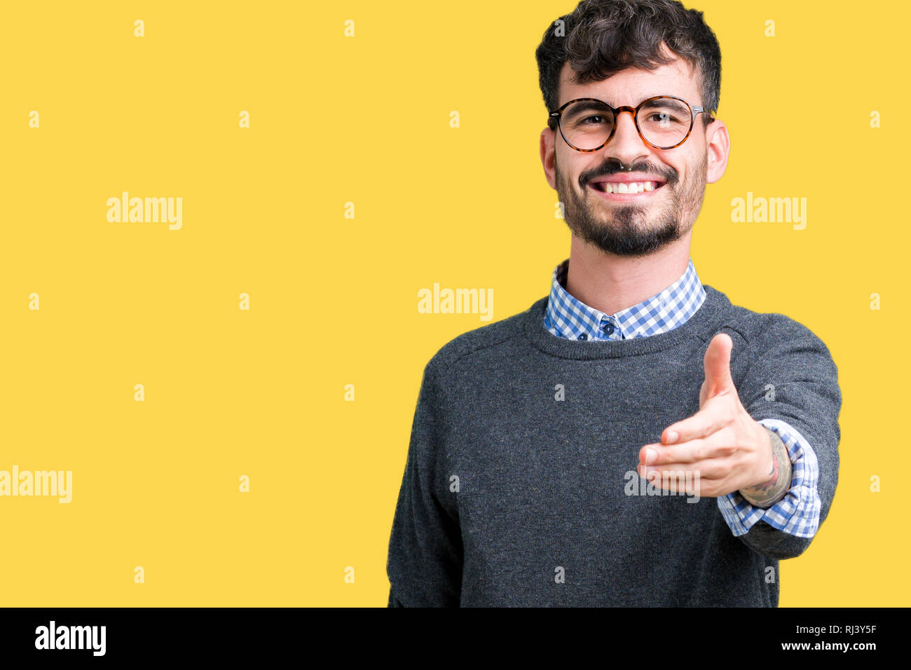 Young handsome smart man wearing glasses over isolated background ...
