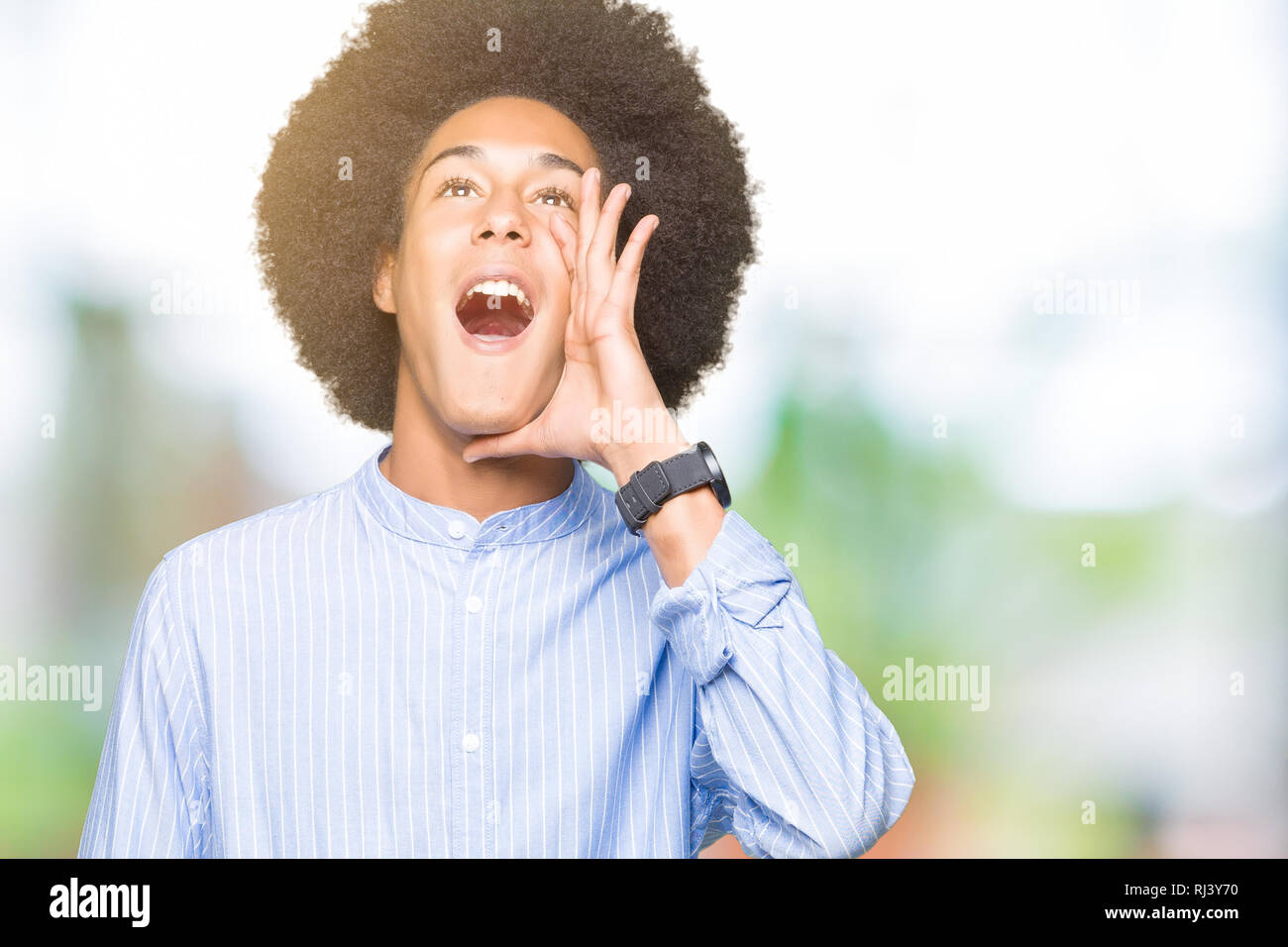 Young african american man with afro hair shouting and screaming loud ...
