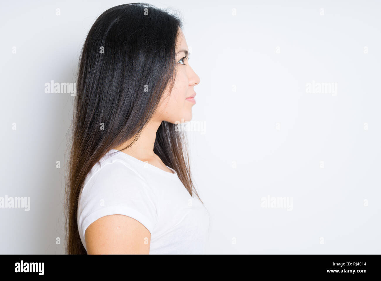 Beautiful brunette woman over isolated background looking to side ...