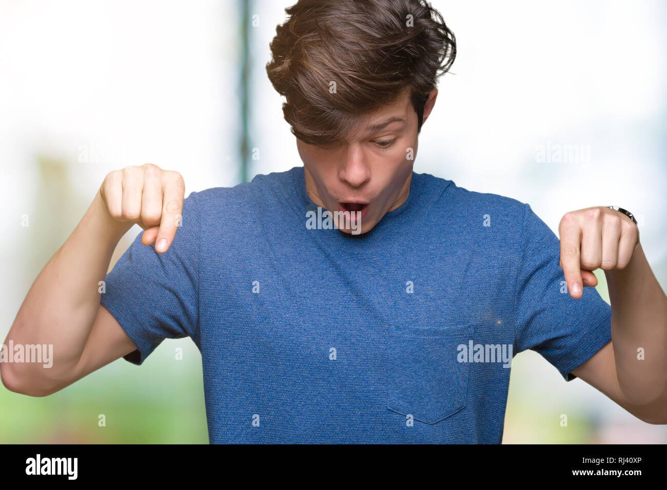 Young handsome man wearing blue t-shirt over isolated background ...