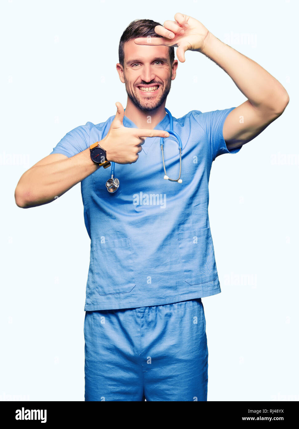 Handsome doctor man wearing medical uniform over isolated background ...