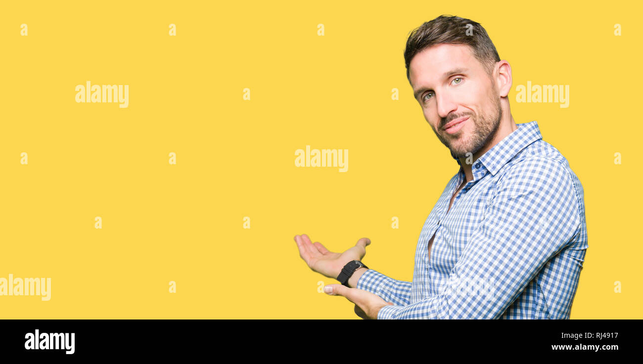 Handsome business man with blue eyes Inviting to enter smiling natural ...