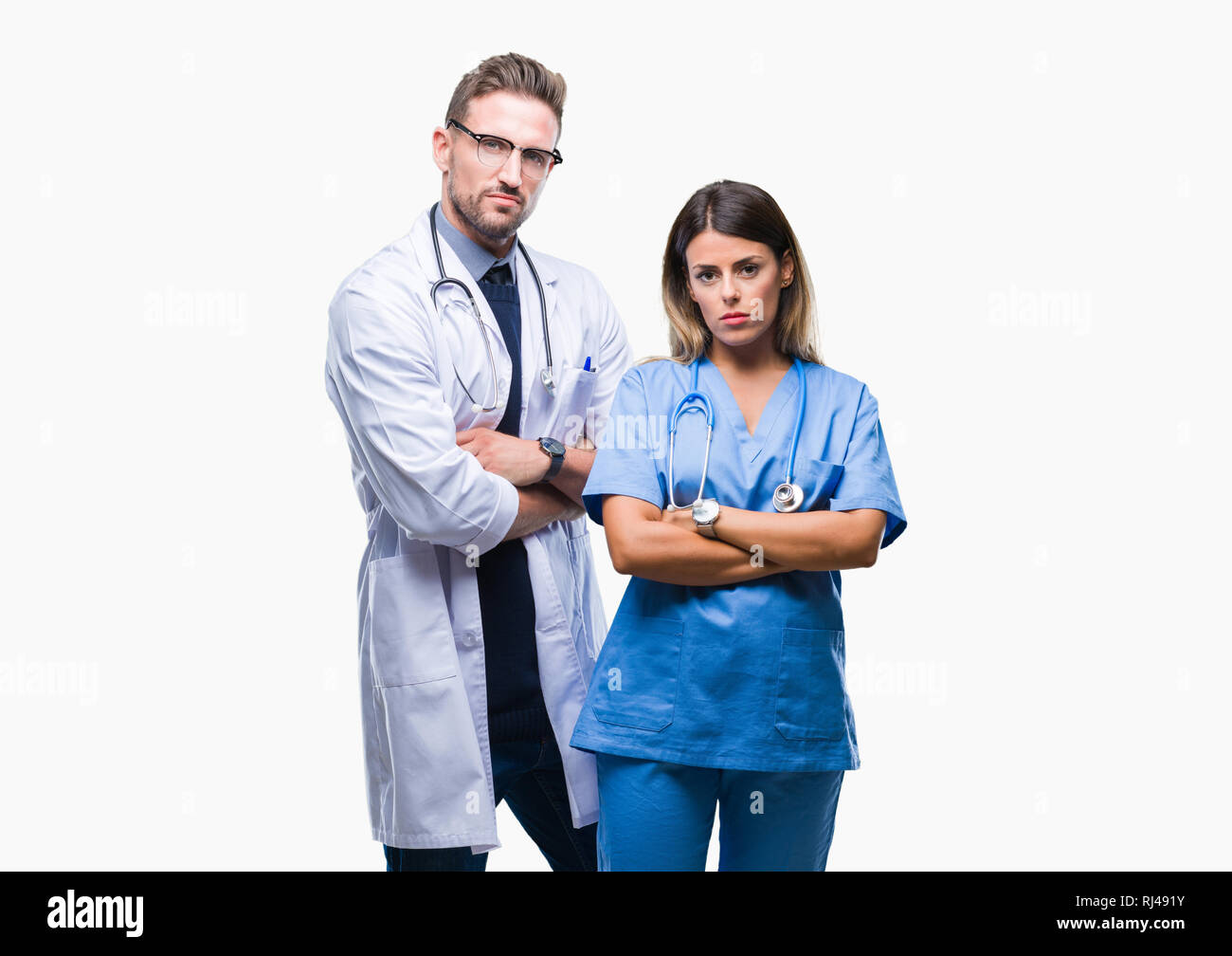Young couple of doctor and surgeon over isolated background skeptic and ...