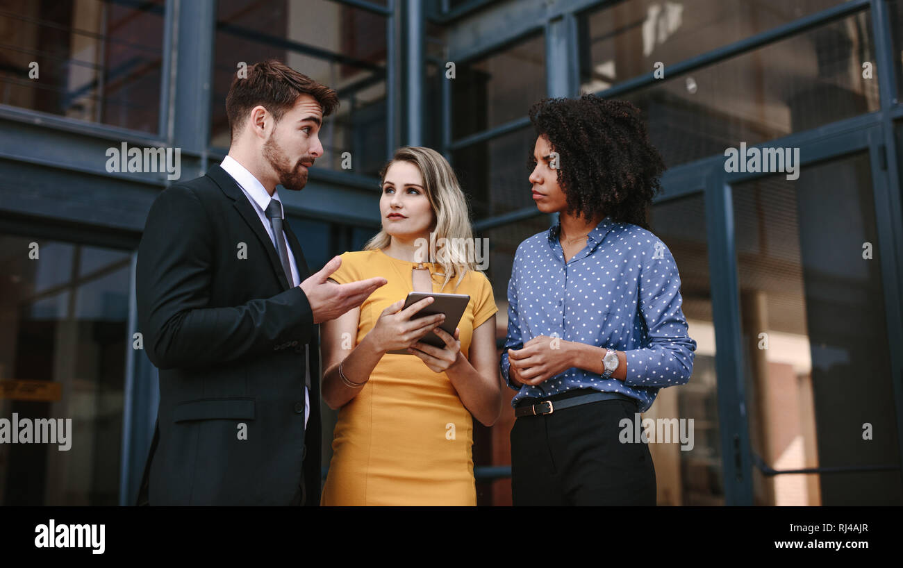 Small group of business people discussing work. Three business ...