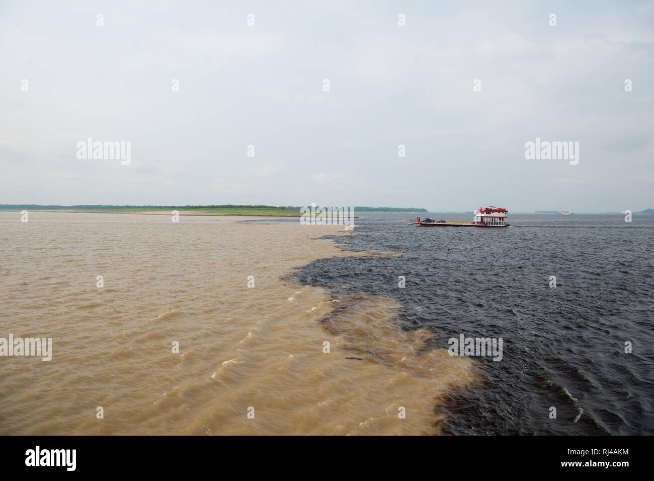 water meeting in brazil -amazon river with rio del negro. transfer boat ...