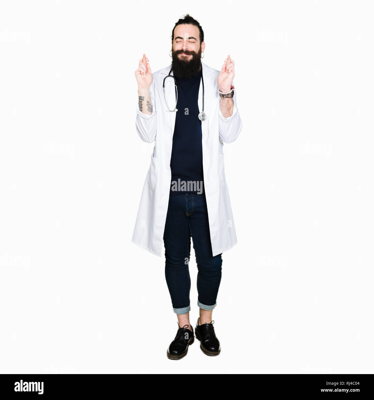 Hopeful young man crossing fingers Cut Out Stock Images & Pictures - Alamy